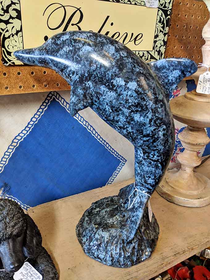 This blue dolphin figurine is ready to make a splash in someone's beach-themed bathroom or quirky living room display.