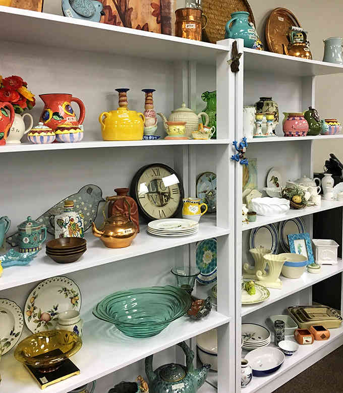 Vintage pottery and colorful ceramics line these shelves like a museum exhibit, except you can actually take them home.