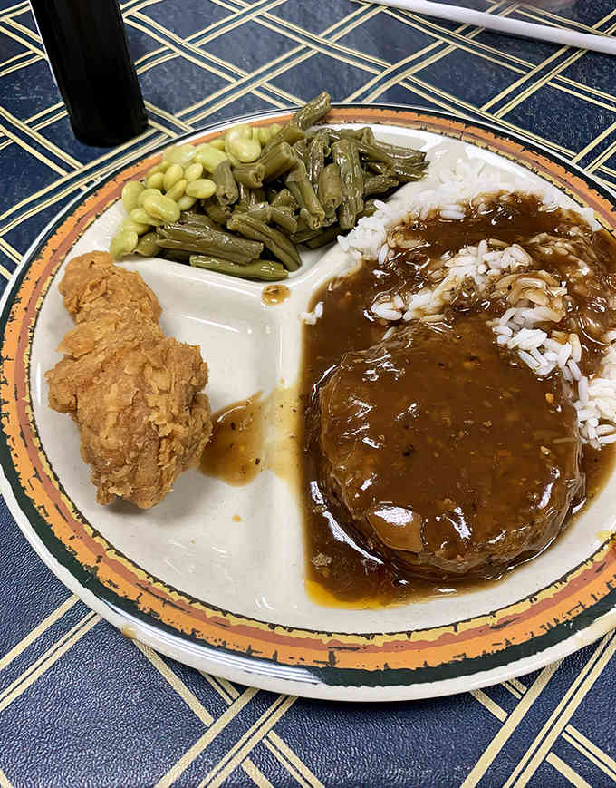 Hash over rice with fried chicken and sides: this is what comfort looks like on a plate.