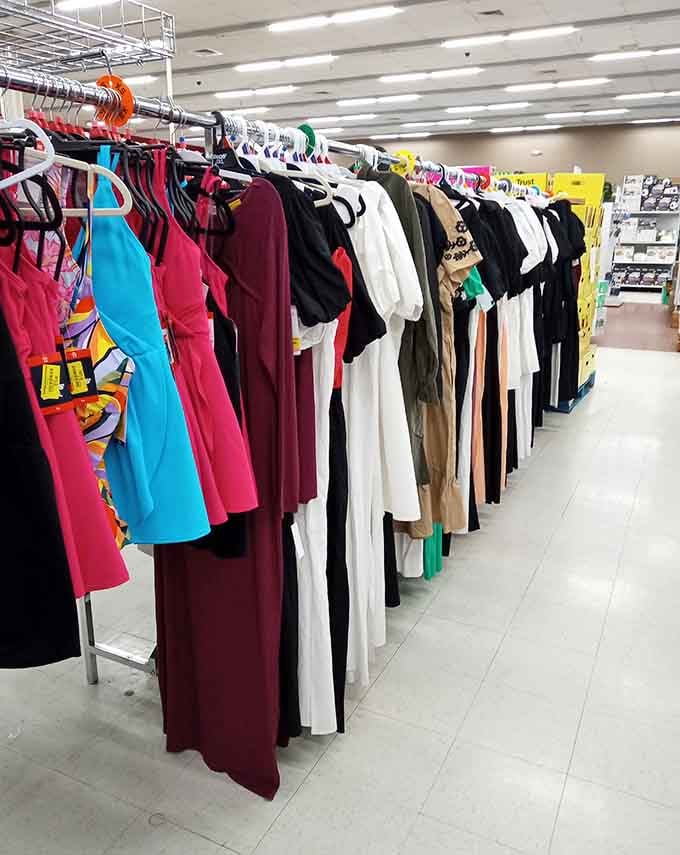 A rainbow of dresses hanging like a vintage department store, proving style doesn't require a second mortgage.
