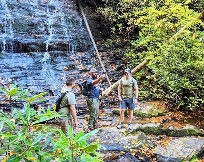 Nothing says "we made it" quite like posing with friends at the base of a waterfall.