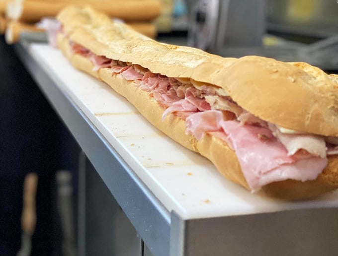Behold the three-footer in its natural habitat, stretching across the counter like edible performance art.