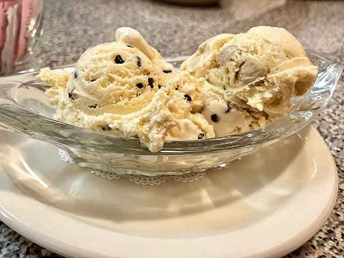 Chocolate chip cookie dough ice cream served in vintage glassware because some traditions deserve proper presentation and reverence.