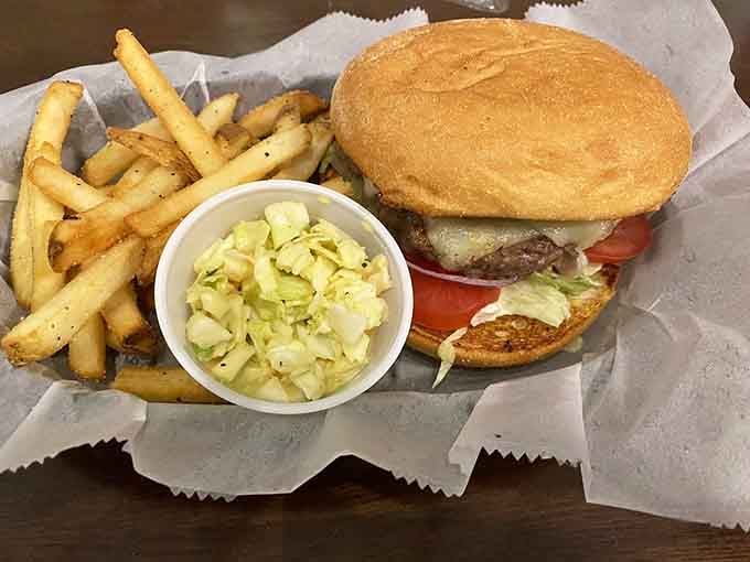 This cheeseburger arrives with golden fries and coleslaw, proving simple done right beats fancy every single time.