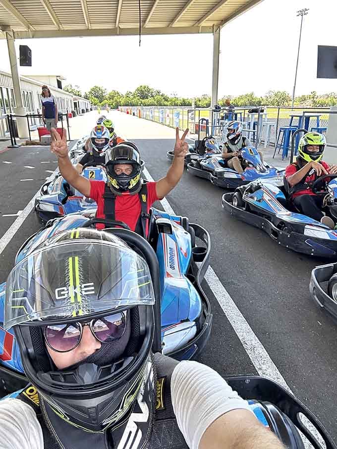 Victory signs and helmets ready, this crew knows the thrill that's about to unfold on the asphalt ahead.
