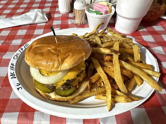 This burger towers like a delicious skyscraper, proving that architecture can be both beautiful and completely edible.