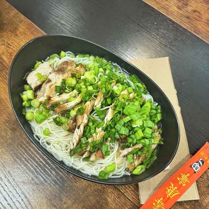 Rice noodles topped with tender chicken and enough green onions to make you feel virtuous about your choices.