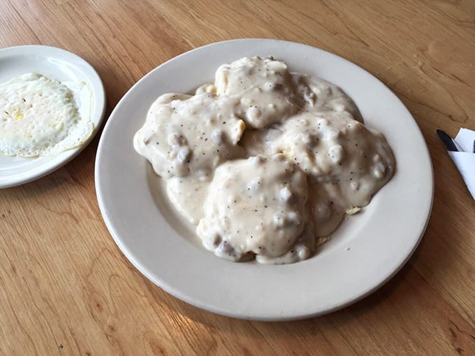 Behold the main event: biscuits drowning in sausage gravy so thick it could double as edible insulation.