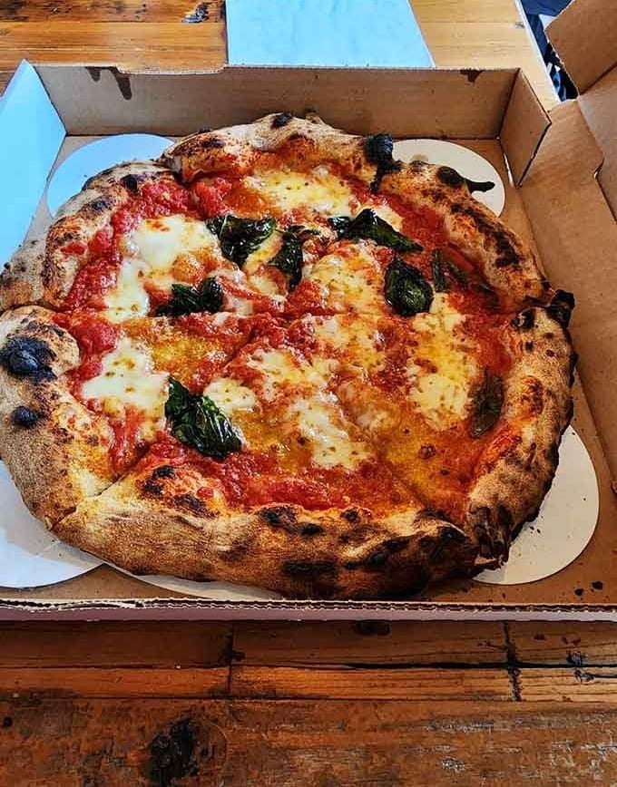 That leopard-spotted crust and bubbling cheese prove sourdough pizza isn't just trendy, it's transformative and utterly delicious.