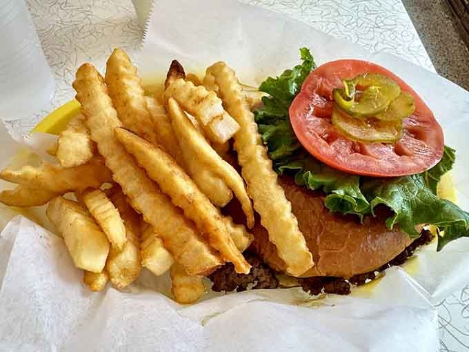Golden crinkle-cut fries meet a perfectly assembled burger, the kind of classic combo that never goes out of style.