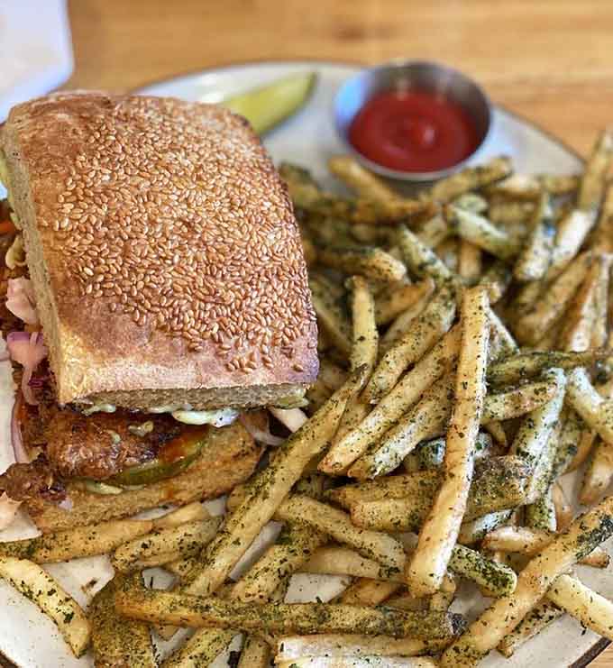 Sesame-studded bread, perfectly seasoned fries, and a sandwich that understands what fried chicken should be.
