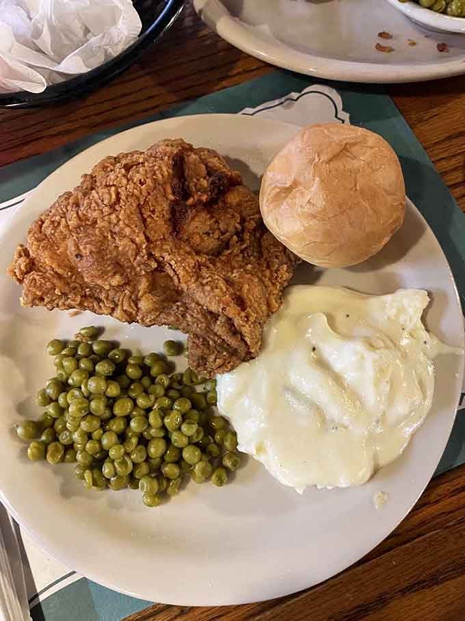 Golden fried chicken so perfectly crispy it could make a vegetarian reconsider their life choices, served with all the fixings.