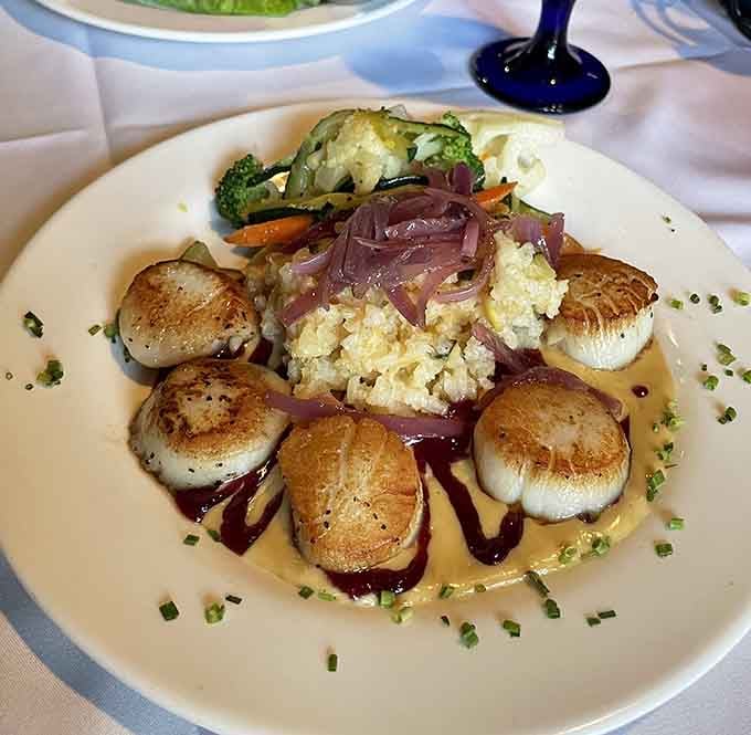 Perfectly seared scallops arranged like edible art, proving that colonial-era buildings can serve seriously contemporary cuisine with style.