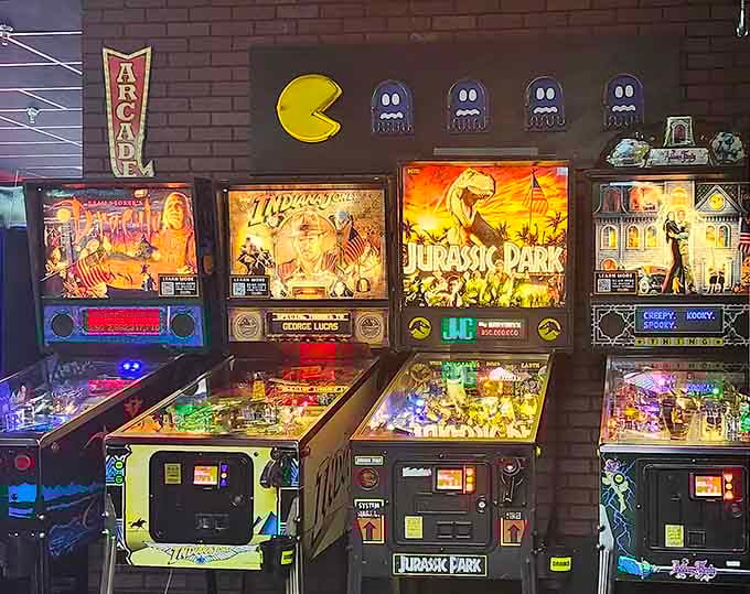 Pac-Man watches over his domain while Jurassic Park and Indiana Jones pinball machines await their next challengers.