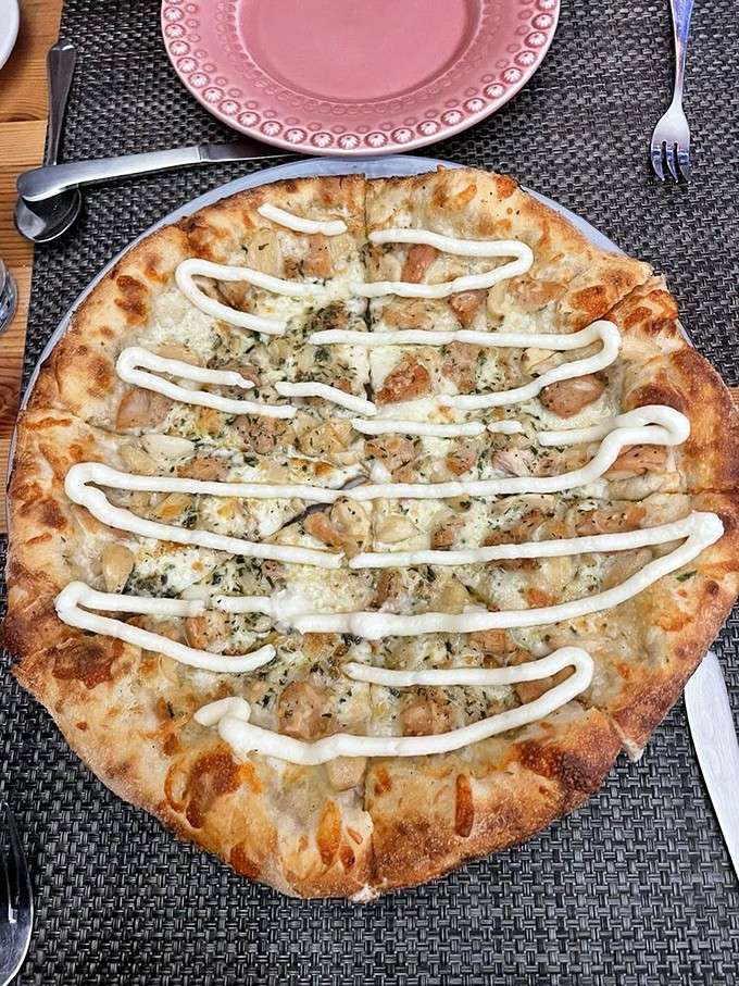 That garlic pizza with chicken gets a drizzle of something creamy that'll make you forget every boring pizza you've ever eaten.