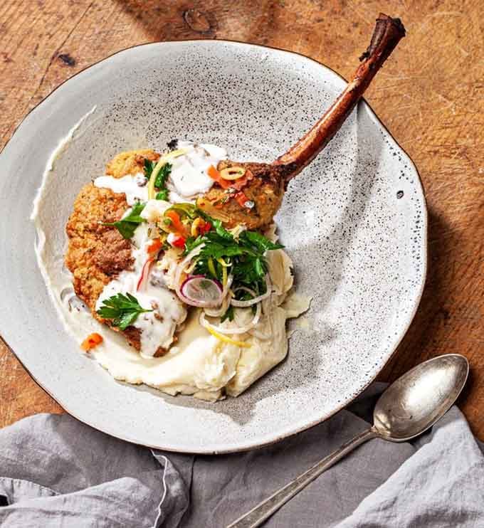 The Bone-In Pork Milanese arrives looking like it stepped off a magazine cover and onto your plate.