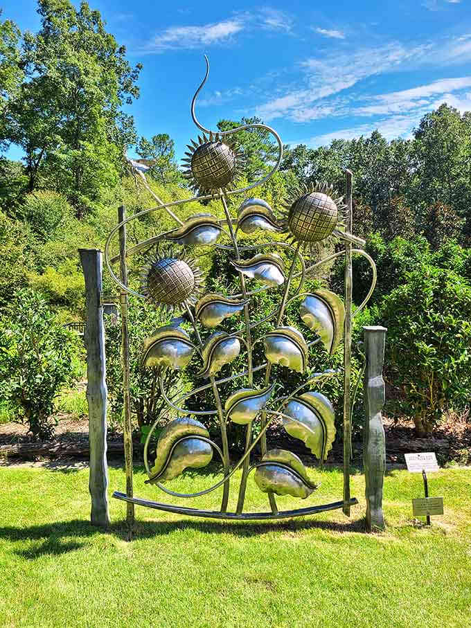 This metallic sculpture catches sunlight like a botanical disco ball, proving art and nature make excellent dance partners.