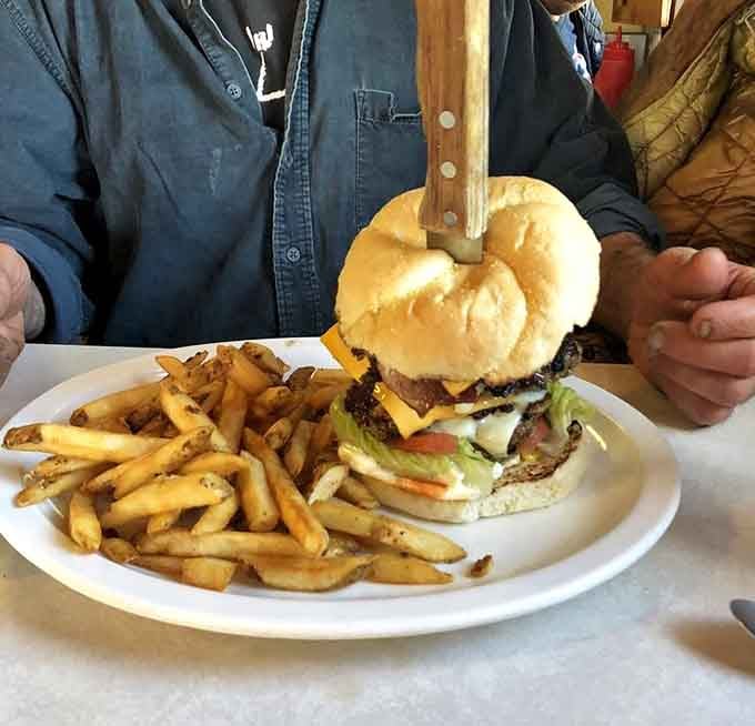 That burger needs a wooden stake just to stay upright, which tells you everything about portion sizes.