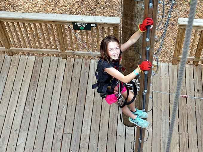 Pure joy radiates from this young climber who's just learned that being brave feels better than staying safely grounded.