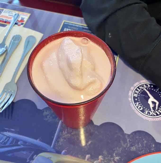 That creamy pink swirl in a metallic cup is basically a hug in drinkable form, sweet and satisfying.