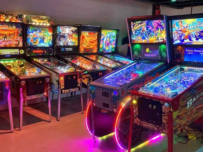 Pinball machines lined up like chrome-and-glass works of art, each backglass telling its own colorful story through lights and design.