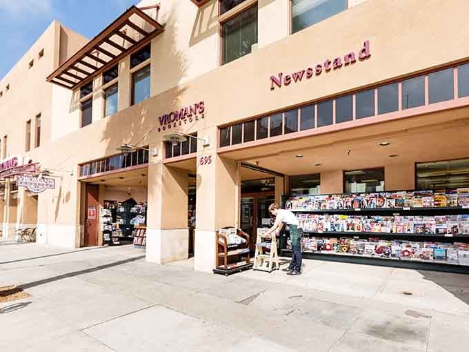 The newsstand spills onto the sidewalk, offering magazines for every interest from knitting to quantum physics.