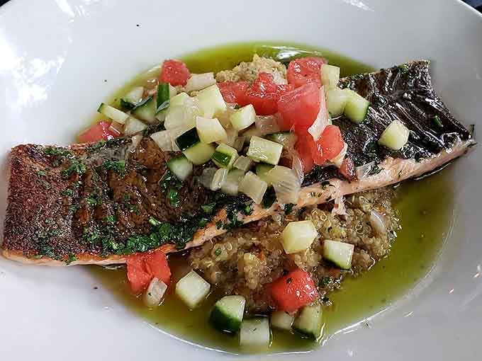 Perfectly seared salmon with quinoa and fresh vegetables proves that healthy food doesn't have to look like punishment on a plate.