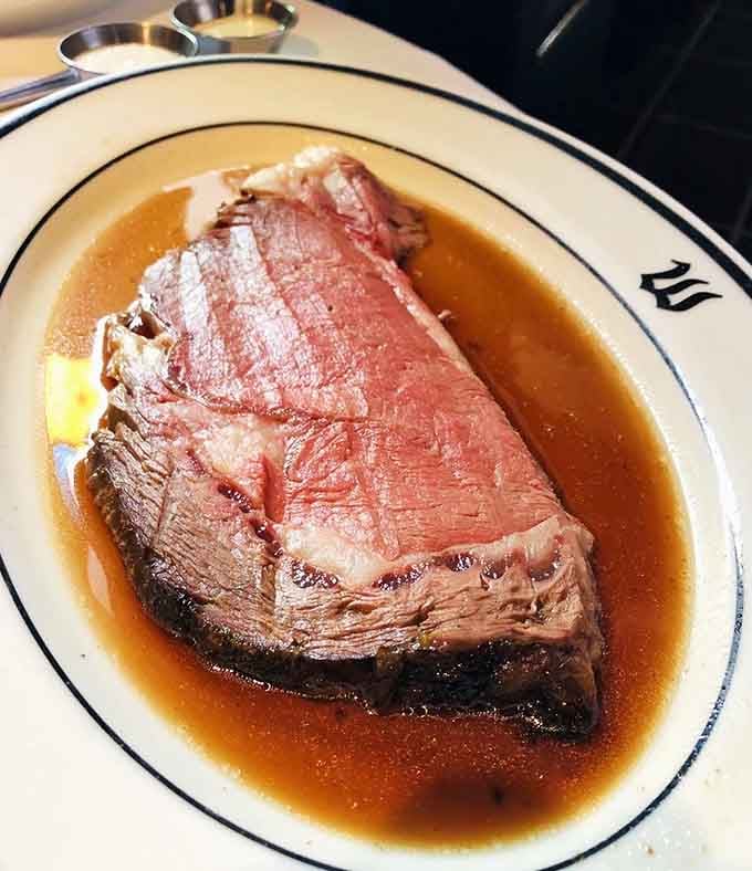 Behold the prime rib in all its glory, swimming in au jus like it's taking a victory lap.