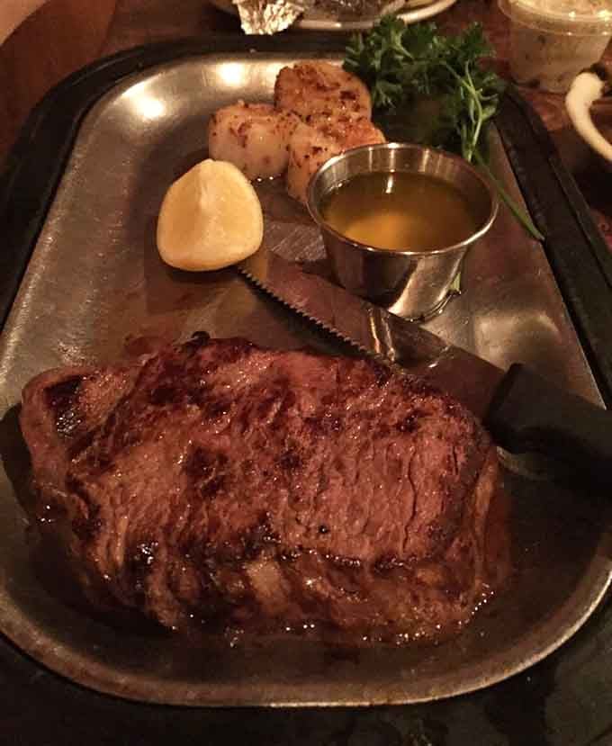 That ribeye paired with perfectly seared scallops proves surf and turf never goes out of style for good reason.