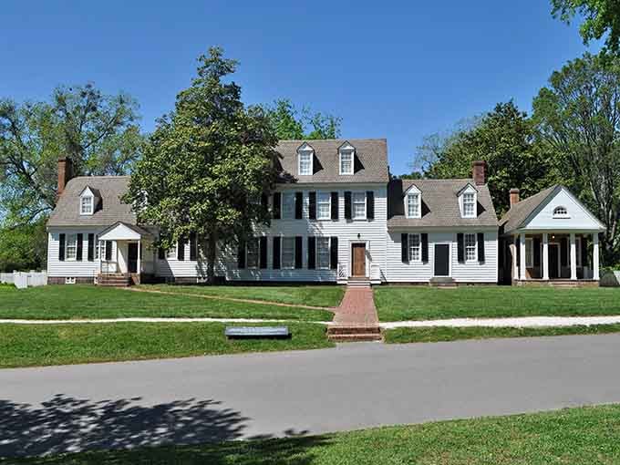Symmetrical colonial elegance with black shutters that would make any HGTV designer weep tears of architectural joy.