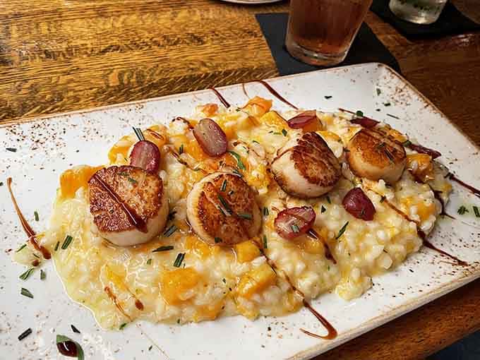 Pan-seared scallops over risotto prove that comfort food can be elegant without losing its soul or satisfaction.