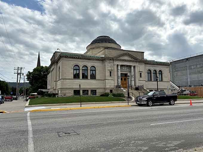 The public library building stands proud, a temple to books in beautiful classical architecture.