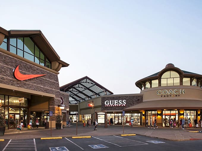 The iconic Nike swoosh towers above, promising deals that'll have you running to the checkout faster than a marathon sprinter.