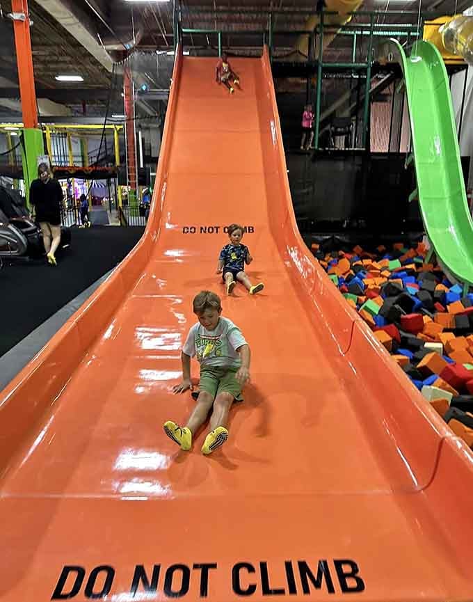 Those slides dump you straight into foam pit paradise, where landing gracefully is optional and belly flops are celebrated.