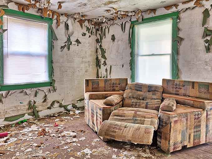 Someone's living room frozen in time, complete with a couch that's seen better decades and way too many leaks.