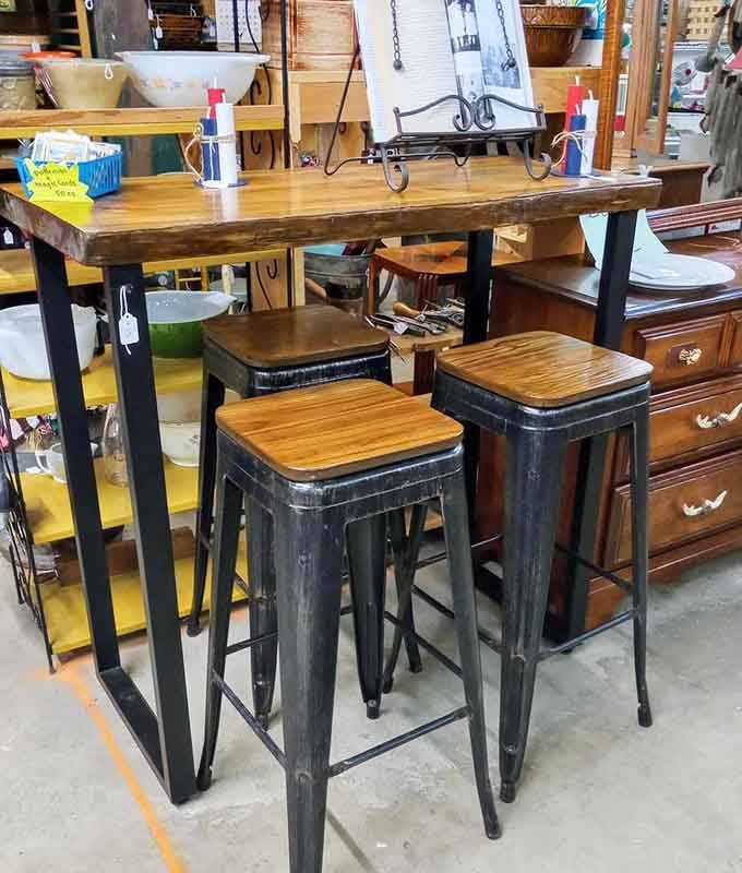 Industrial chic meets farmhouse charm in this perfectly weathered table and stool set for modern living.