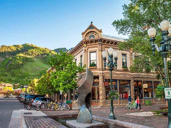 That corner building's ornate architecture catches golden light while ski slopes create the perfect backdrop for browsing.