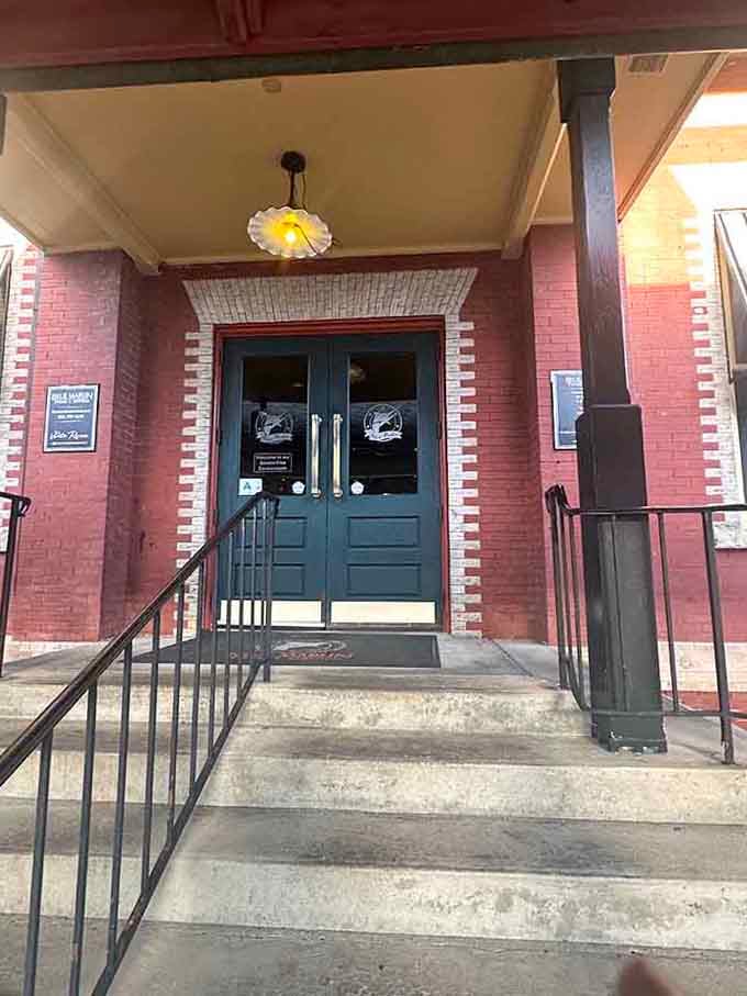 That classic brick entrance with vintage lighting fixtures welcomes you like an old friend coming home for dinner.