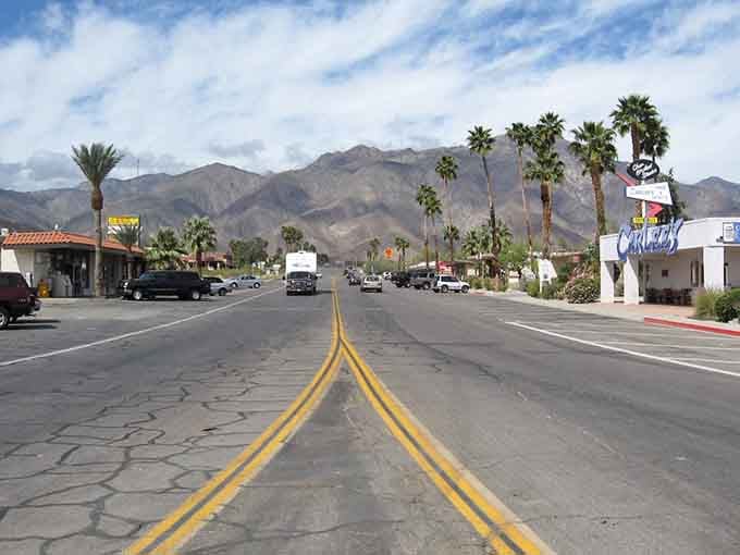 Desert mountains rise dramatically behind palm-lined streets where the landscape feels almost otherworldly and magnificent.