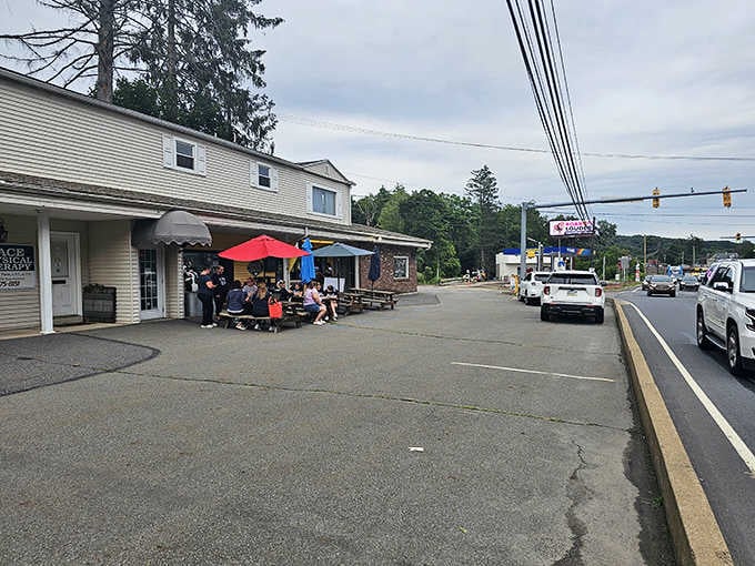 Community gathers under red umbrellas where simple pleasures meet small-town charm and everyone knows good ice cream.