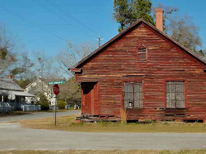 This weathered red building stands as a testament to simpler times, when a handshake meant something and neighbors knew neighbors.
