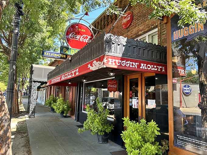 The bright Coca-Cola sign and cheerful red awning make this corner spot impossible to miss on any street.