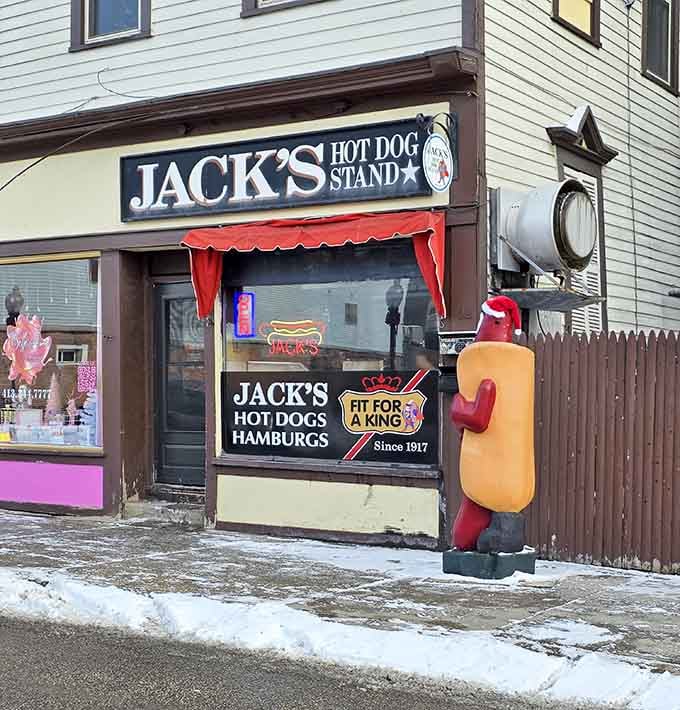 Jack's cheerful mustard mascot standing guard in the snow proves hot dog season never really ends here.