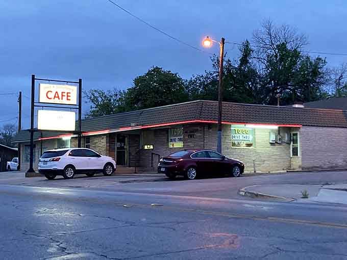 That glowing sign at dusk calls to hungry travelers like a beacon of comfort food salvation.