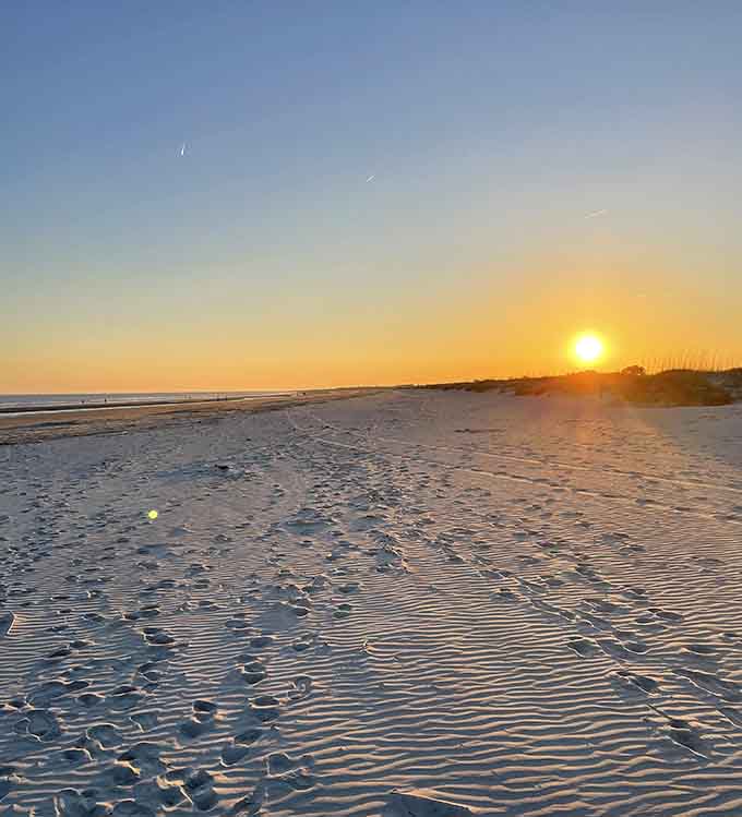 Golden hour on this beach creates rippled sand patterns that look like nature's own fingerprint in the shoreline.