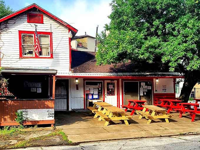 Bright picnic tables in red and yellow create a cheerful outdoor dining spot that's pure Americana charm.
