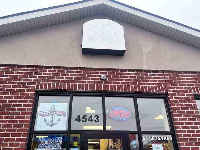 Clean brick lines and that simple "Donut Factory" sign above promise honest craftsmanship without any unnecessary fuss or fanfare.