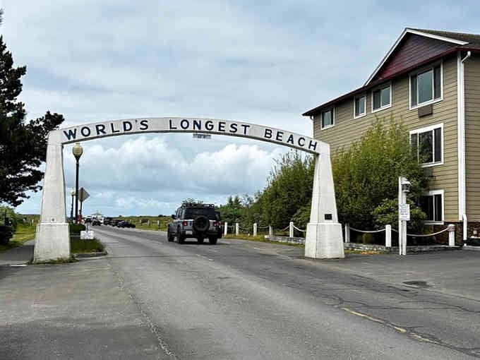 When the arch literally announces "World's Longest Beach," you know you're in for some serious sandy adventures ahead.
