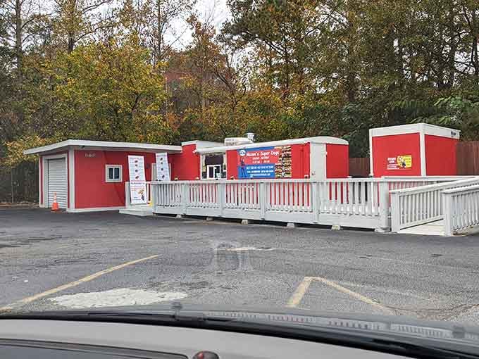 The bright red building with white railings stands ready to serve up creative hot dog combinations you never knew existed.