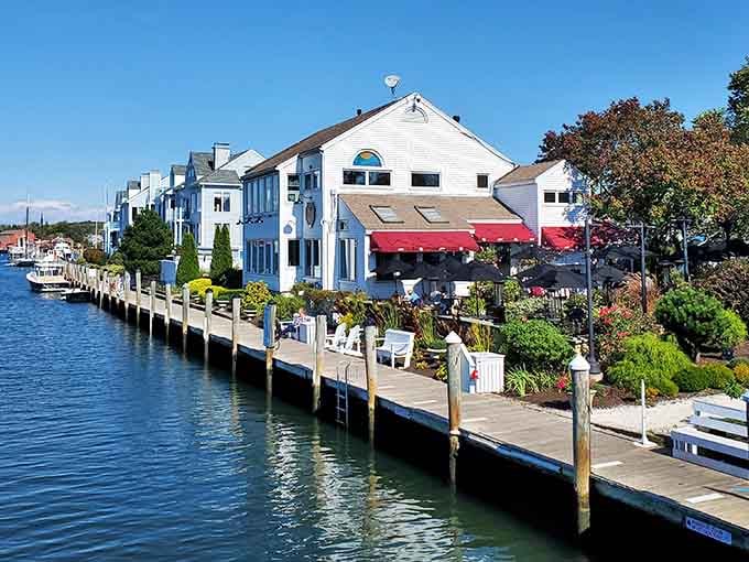Red awnings pop against waterfront blues like a perfectly composed postcard that somehow came to life before you.